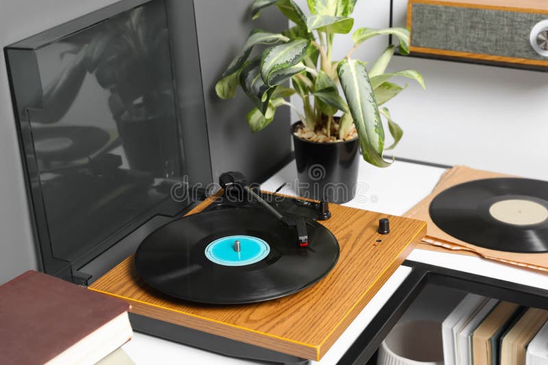 Stylish Turntable with Vinyl Disc Near Grey Wall in Room Stock Photo ...