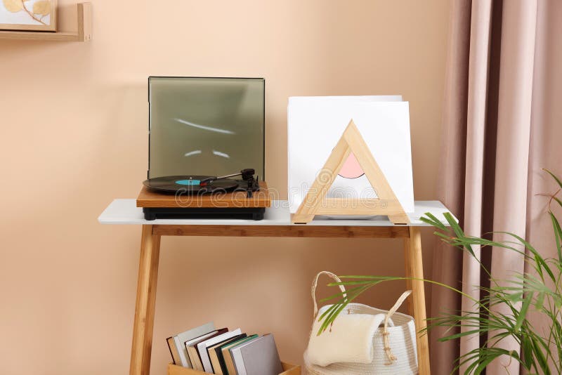 Stylish Turntable with Vinyl Record on Console Table in Cozy Room Stock ...