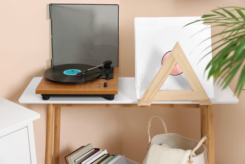 Stylish Turntable with Vinyl Record on Console Table in Room Stock ...