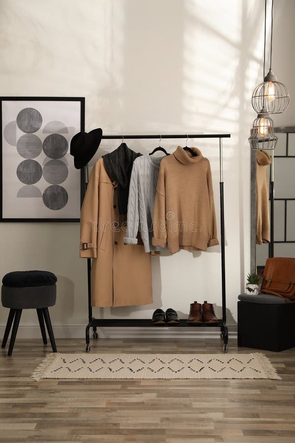 Stylish Warm Clothes on Rack in Dressing Room Interior Stock Image ...