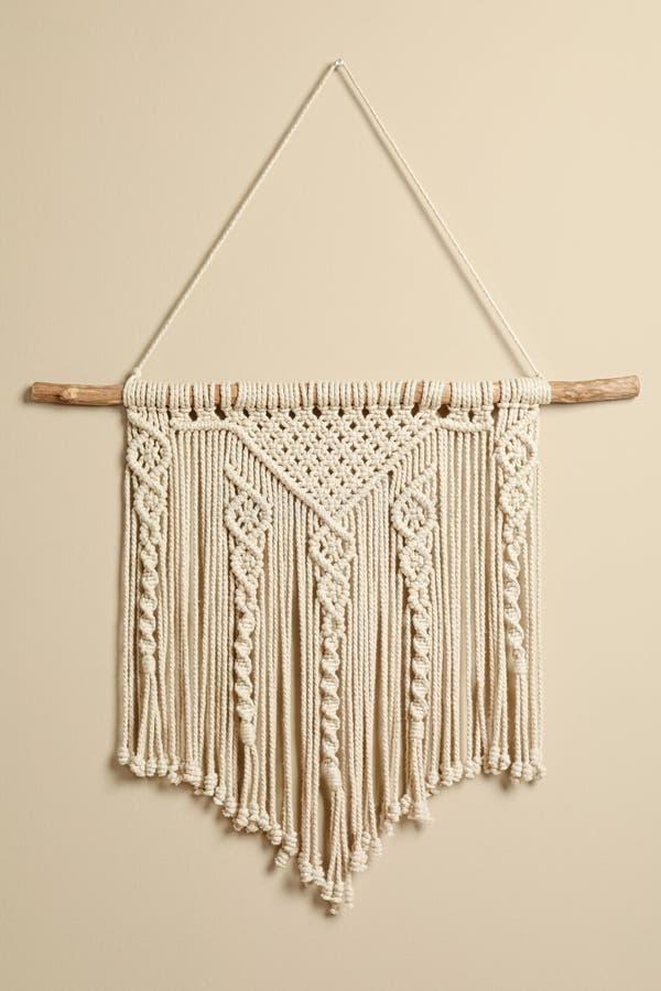 Stylish White Macrame Hanging on Beige Wall Stock Photo - Image of hand ...