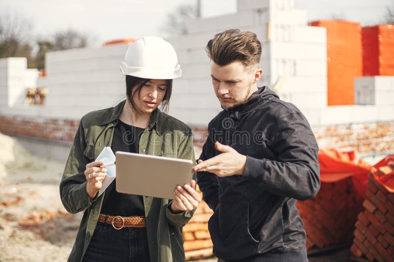 Stylish Woman Architect with Tablet and Contractor Man Checking ...
