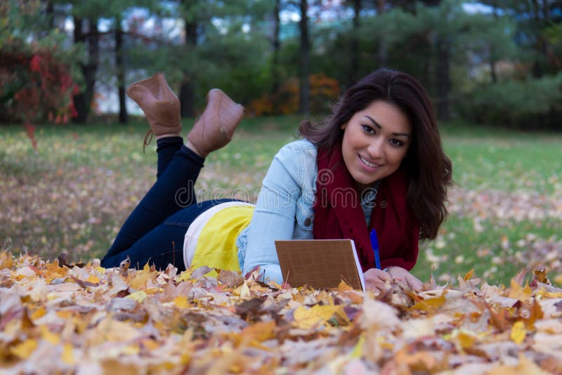 Stylish Woman Writing in Her Notebook Outdoors during Autumn Stock ...