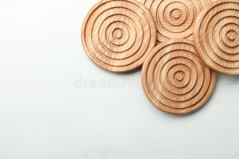 Stylish Wooden Cup Coasters on White Marble Table, Top View. Space for ...