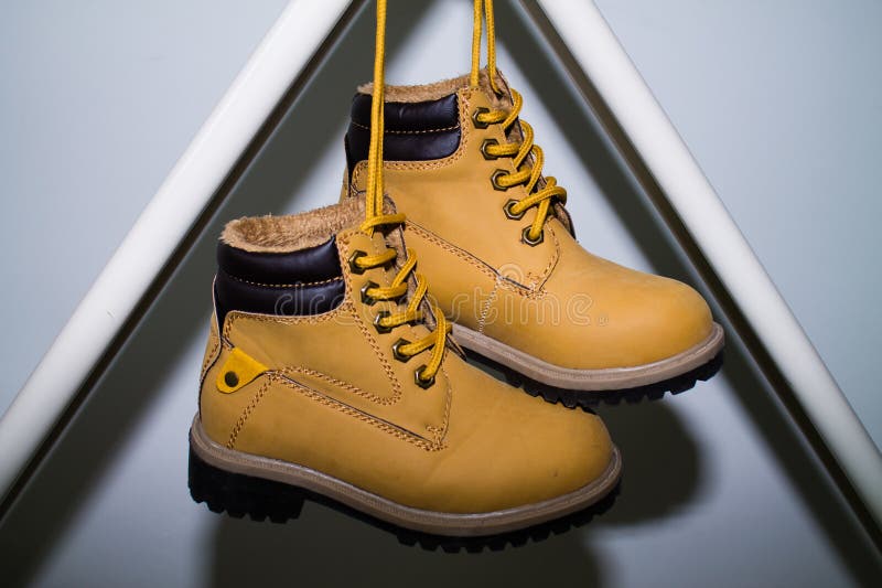 Stylish Yellow Work Boots Hanging Display Stock Image - Image of kind ...