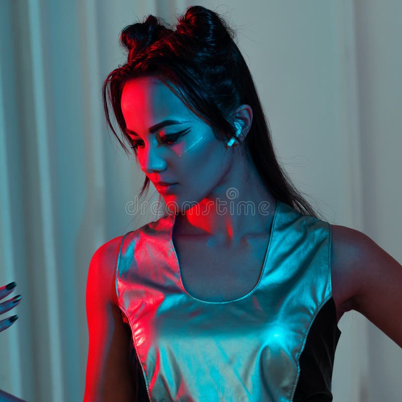 Stylish Young Girl in Silver Top. Portrait in Futuristic Cyberpunk ... Stylish Young Girl in Silver Top. Portrait in Futuristic Cyberpunk ...