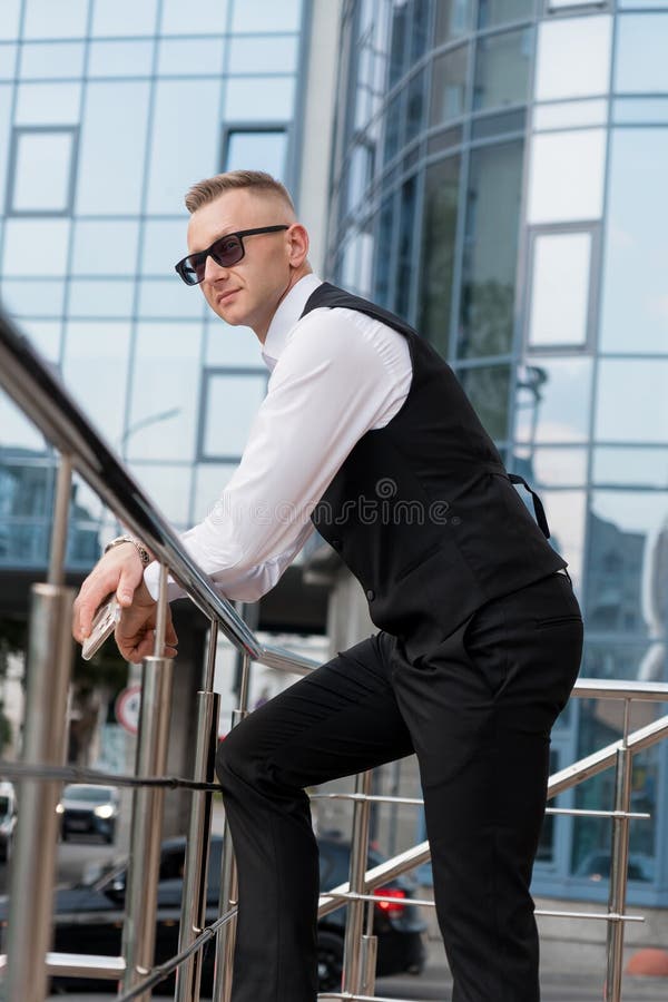 Stylish Young Man in Formal Attire Posing Outdoors with Sunglasses ...