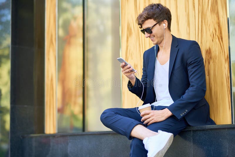 Stylish Young Man with Smartphone Outdoors Stock Photo - Image of ...