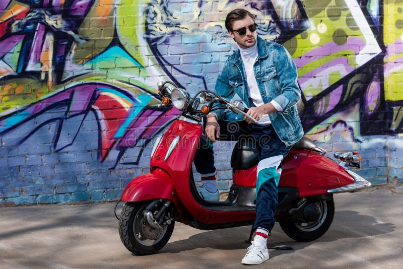 Stylish Young Man on Vintage Red Scooter in Front of Brick Wall Stock ...