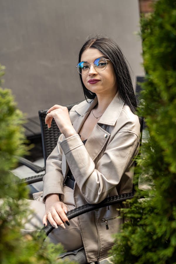Stylish Young Woman Sitting at an Empty Table and Waiting for Her ...