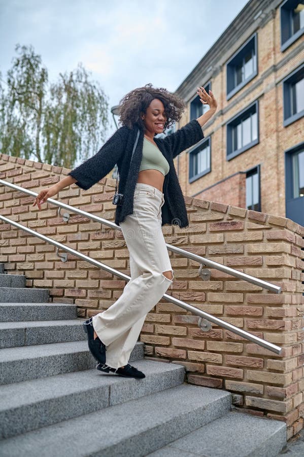 A Stylish Young Woman on the Steps Stock Photo - Image of shooting ...