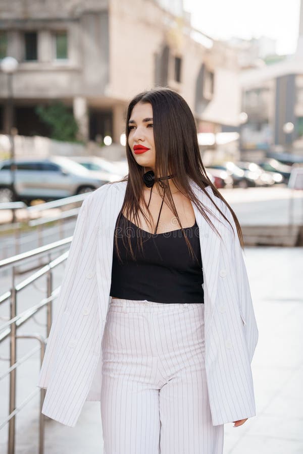 Stylish Young Woman in Urban Setting Wearing Striped Suit and Confident ...