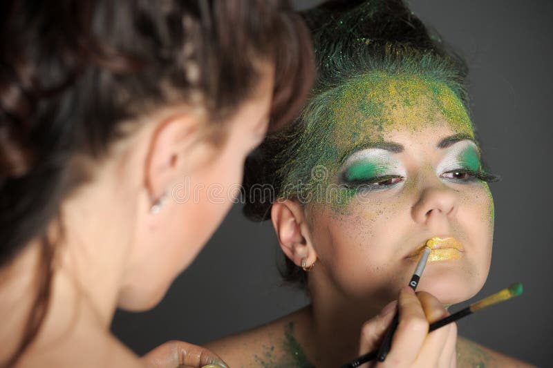 Stylist makes makeup model stock photo. Image of makeup - 168452828