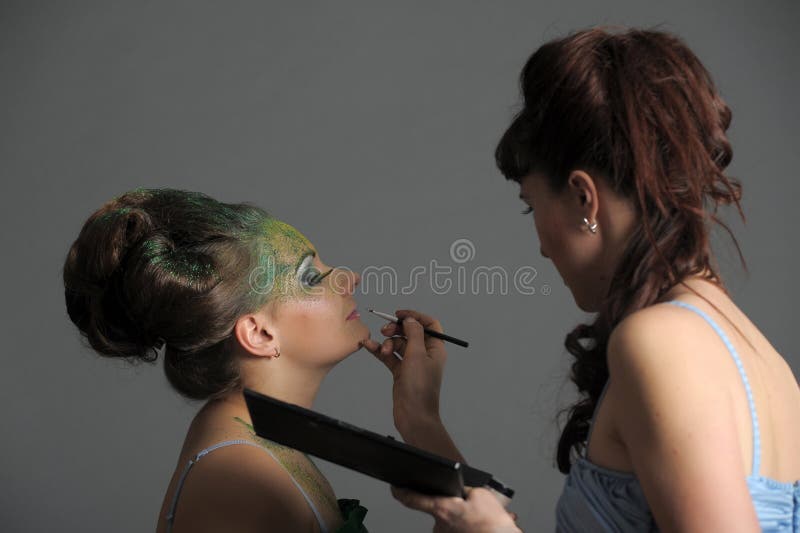 Stylist makes makeup model stock photo. Image of lovely - 168453172