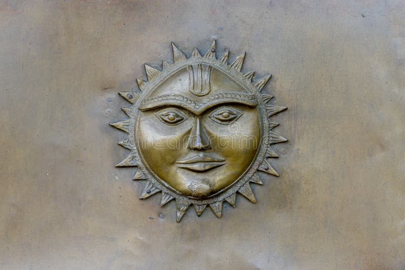 Stylized Bronze Sun with Face Looking Serious from Under Large Eyebrows ...