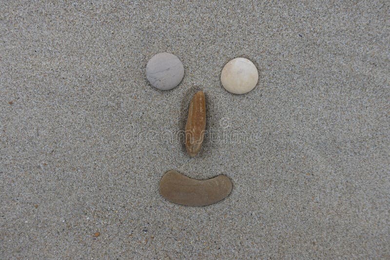Stylized Face Composed with Pebbles on the Beach Stock Image - Image of ...