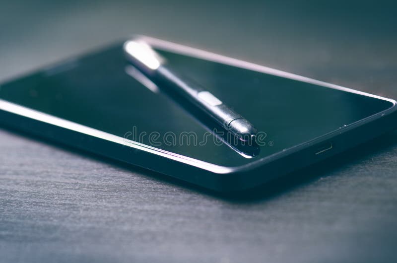 Stylus Pen on a Smart Phone. Dark Background. Technology Mobile. Stock ...