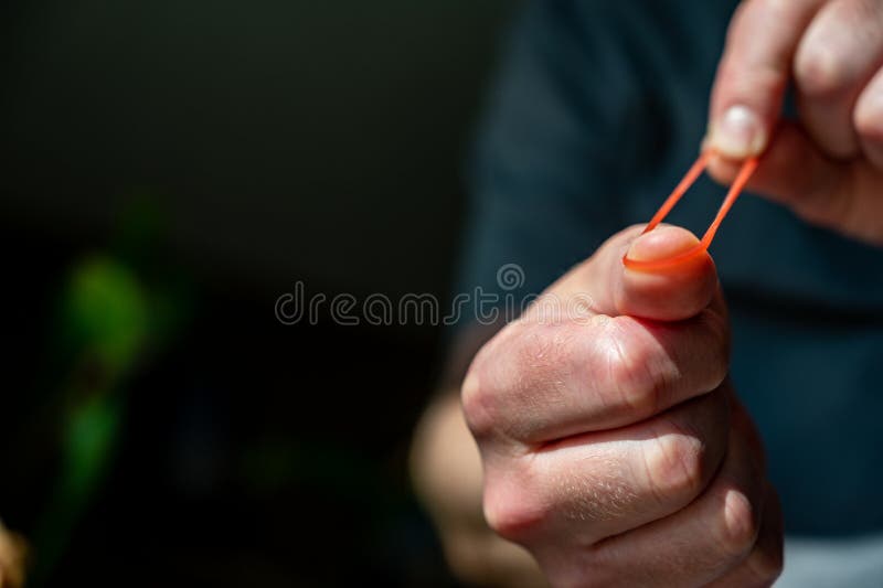 Subjective Focus on Rubber Band Pulled Taunt Being Aimed at the Camera ...