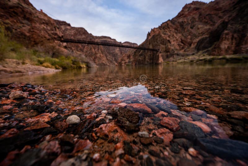 Submerged Rocks in the Colorado River with the Black Bridge Stock Image ...