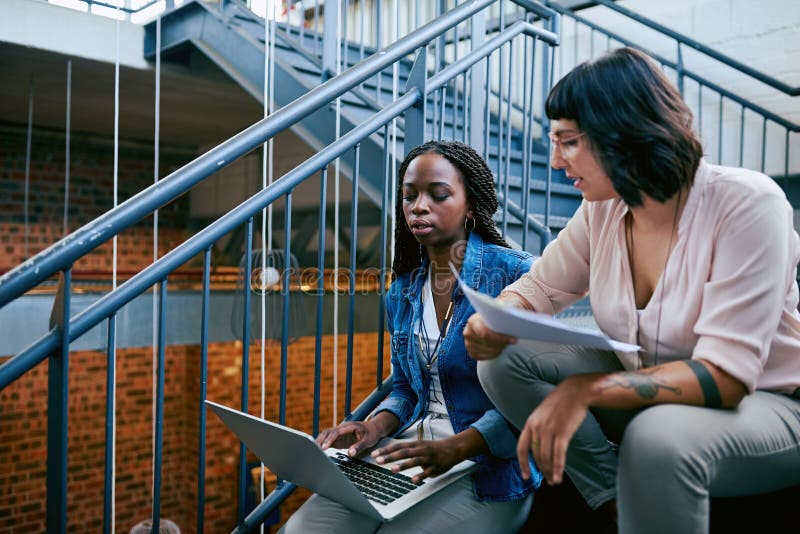 Submitting Their Project Online. Two Colleagues Collaborating in a ...