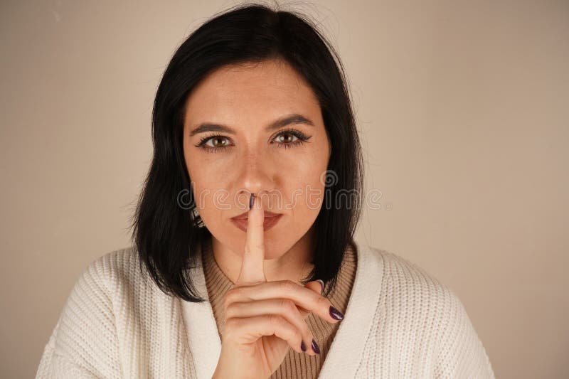 A Subtle and Timeless Gesture, Understood by All. One Finger Placed on ...