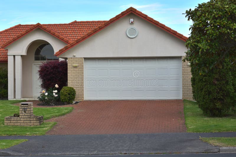 Suburban Garage with White Roller Door Stock Image - Image of garage ...