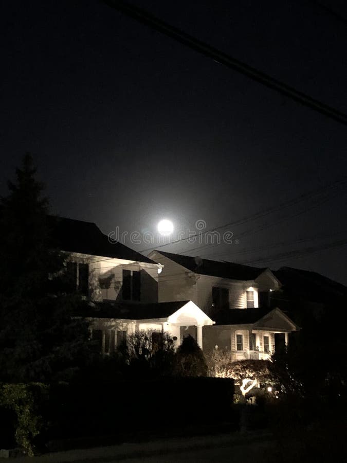 The moon over houses stock photo. Image of architecture - 191729826