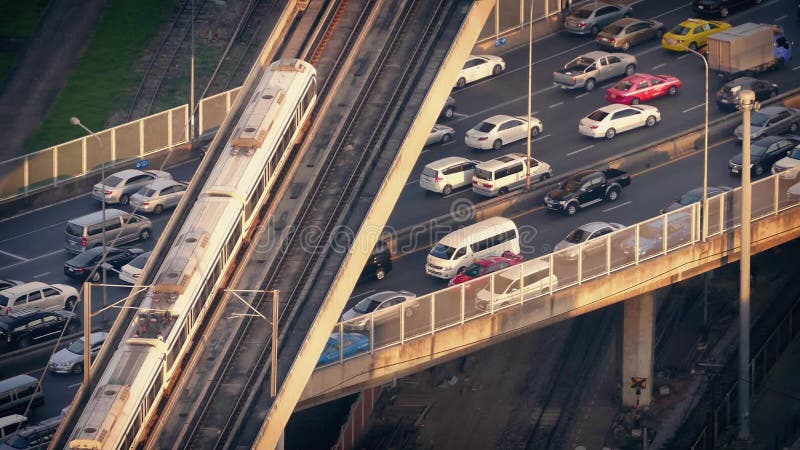Subway Train Passes Over Cars on Highway Stock Video - Video of evening ...