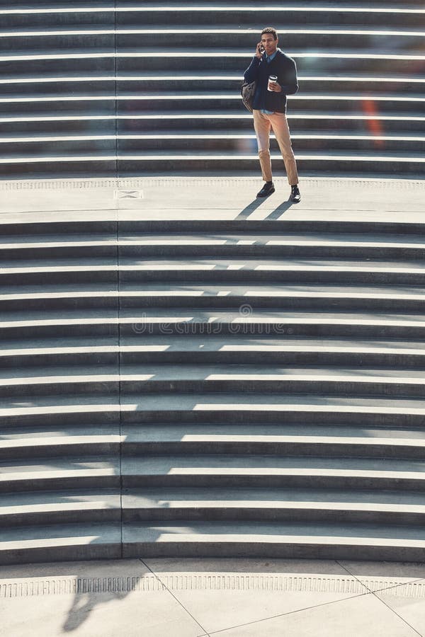 Success is Calling Him. a Young Businessman Using a Mobile Phone while ...