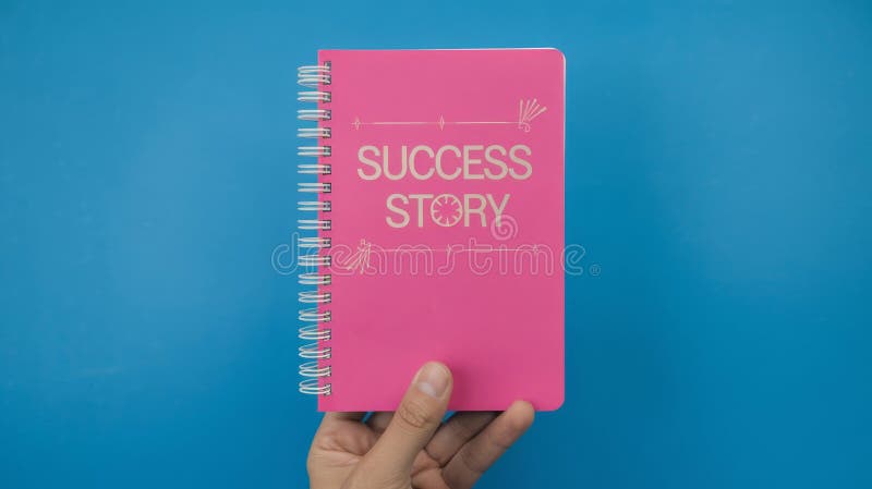 Success Story Text on Pink Notebook Held by Hand with Blue Background ...