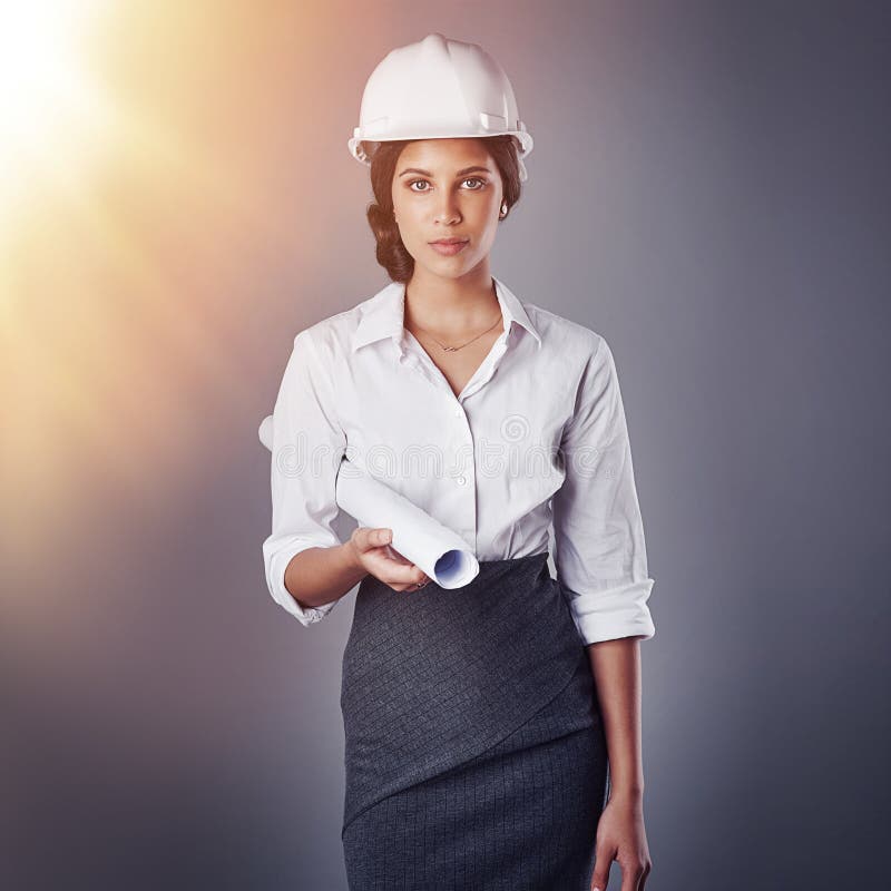 Success Under Construction. Portrait of a Well-dressed Civil Engineer Posing while Holding ...