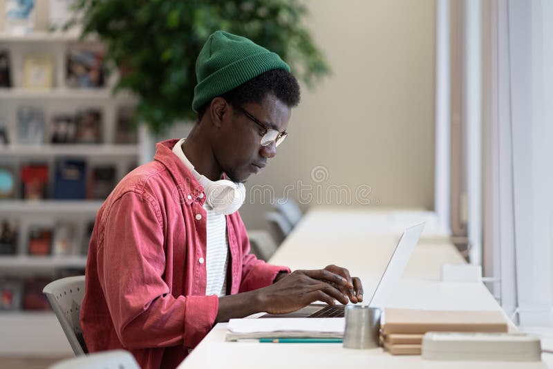 Successful African American Guy Programmer is Typing Code in Laptop ...