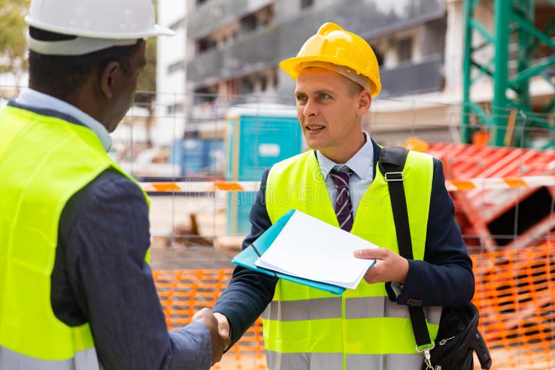 Successful Architect and Engineer Shake Hands on Construction Site ... Successful Architect and Engineer Shake Hands on Construction Site ...