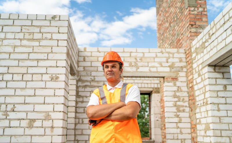 Successful Builder in Hardhat Controls Quality of Work at Construction ...