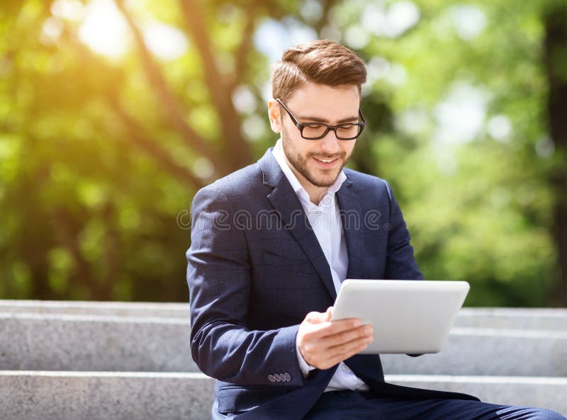 Successful Business Leader Using Tablet at Green Park on Sunny Day ...