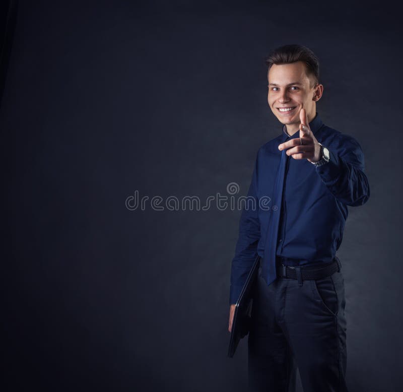 Successful Business Man on a Dark Background with a Laptop. Stock Photo ...