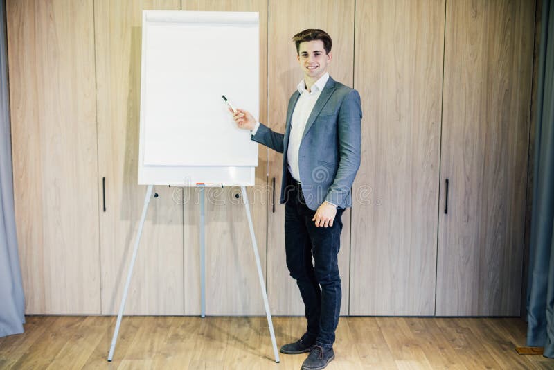 Successful Business Man with a Flip Chart in a Presentation in Modern ...
