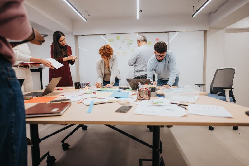 Multiethnic Business Team Collaborating in a Workshop, Discussing ...