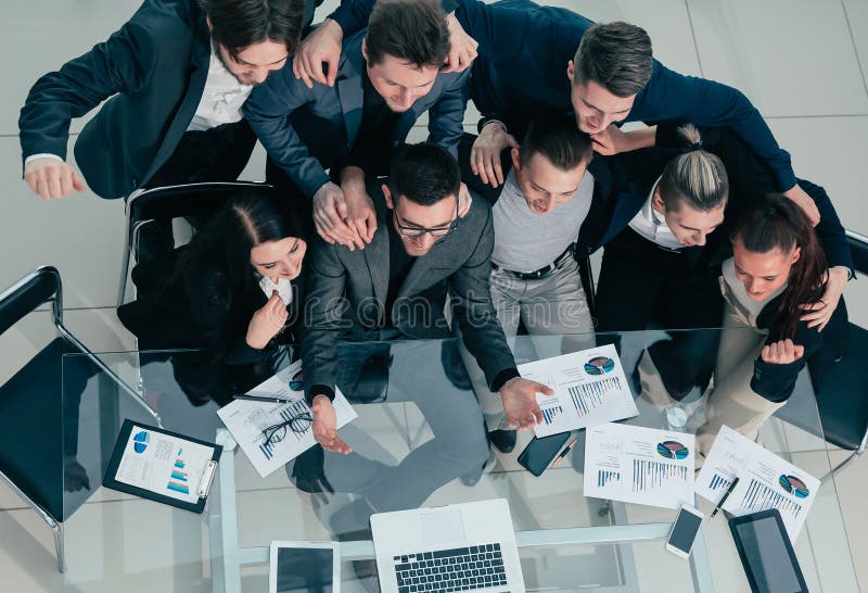 Successful Business Team Sitting at a Desk and Looking at the Camera ...