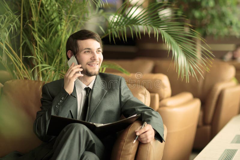 Successful Businessman with Business Papers Talking on the Smartphone ... Successful Businessman with Business Papers Talking on the Smartphone ...