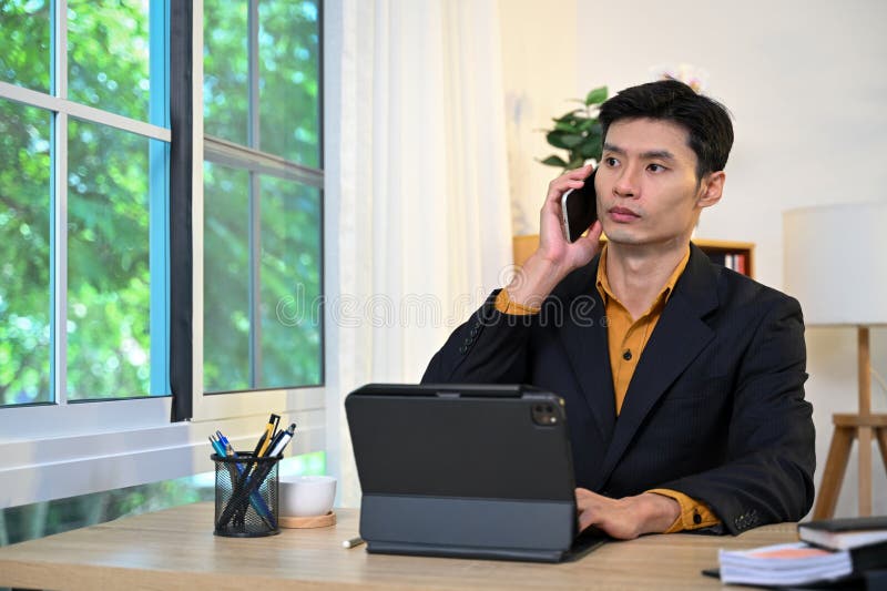 Successful Businessman in a Formal Suit Talking on Mobile Phone in the ...