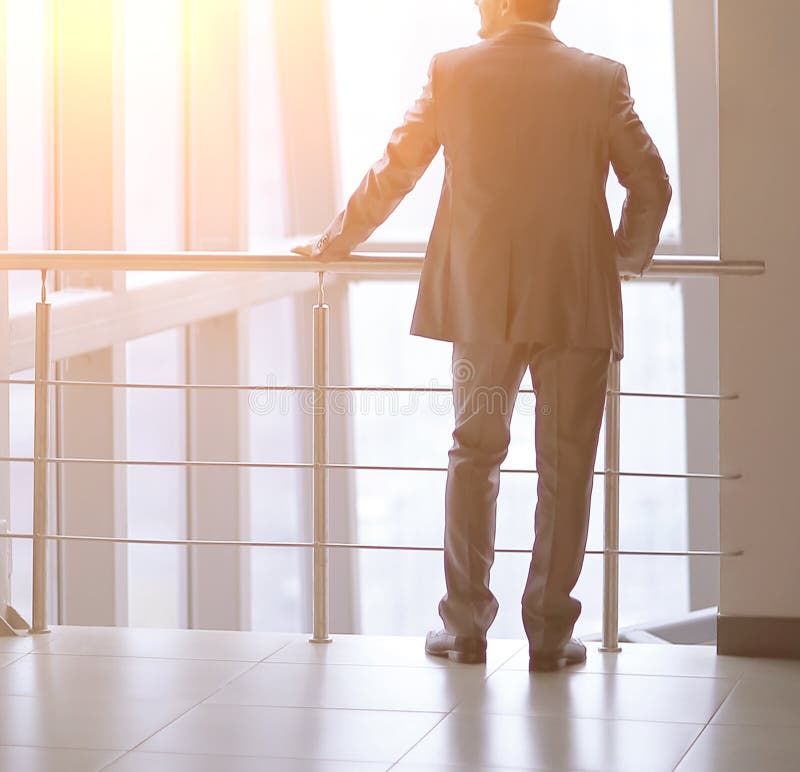 Successful Businessman Standing in the Lobby of a Modern Office Stock ... Successful Businessman Standing in the Lobby of a Modern Office Stock ...