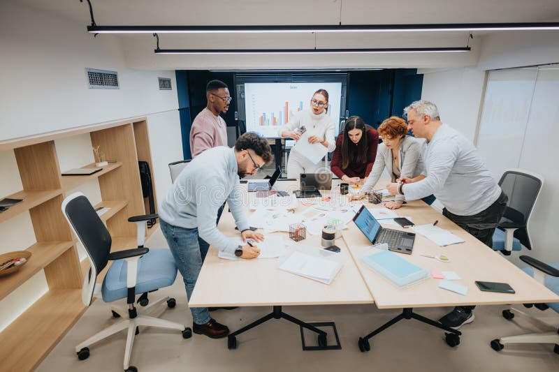 Successful Businesspeople Collaborating and Discussing Statistics in a ...