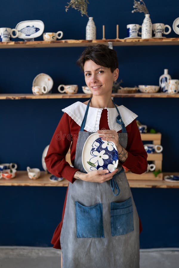 Successful Ceramics Studio Owner Posing with Handmade Plate at ...