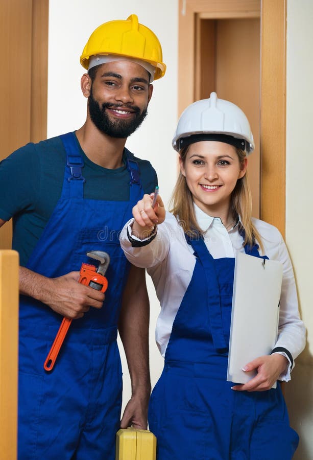 Team of Builders Brainstorming and Smiling Indoors Stock Image - Image ...