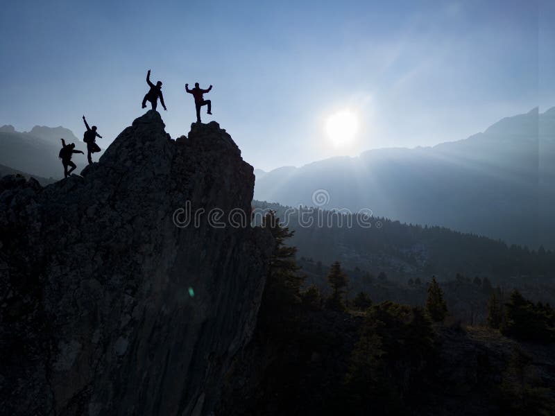 Successful Climbers on the Jagged Cliff at the Top of the Mountains ...