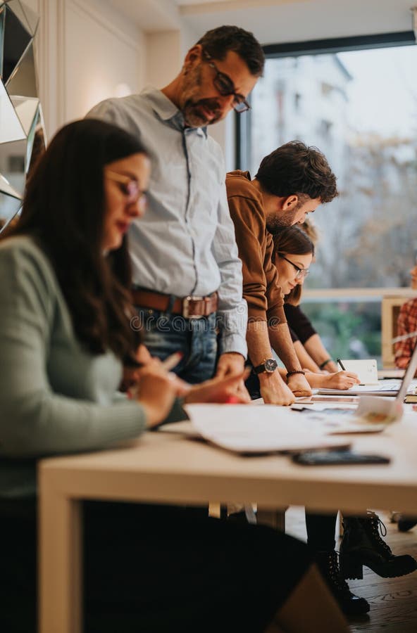 Successful and Concentrated Business Team Collaborating on a Project. a ...