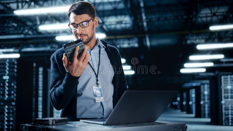 Successful Data Center it Specialist Using Laptop Computer. Server Farm ...