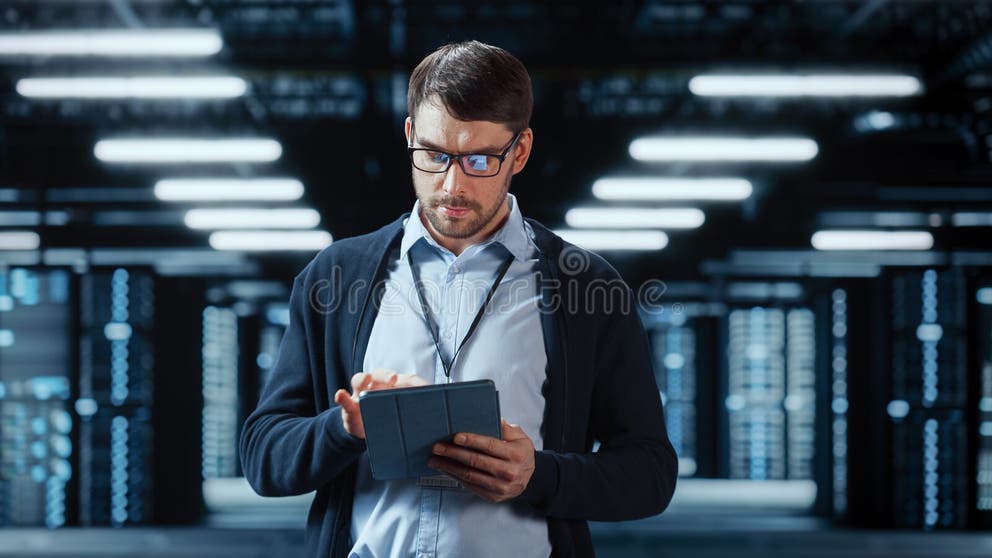 Successful Data Center it Specialist Using Tablet Computer. Server Farm ...
