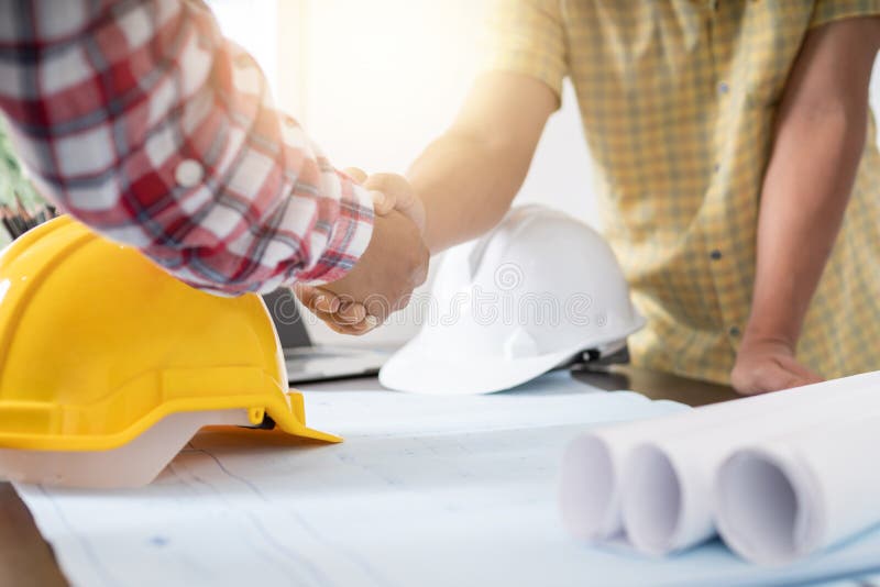 Architect Contractor Shaking Hands with Client at Construction Site ...